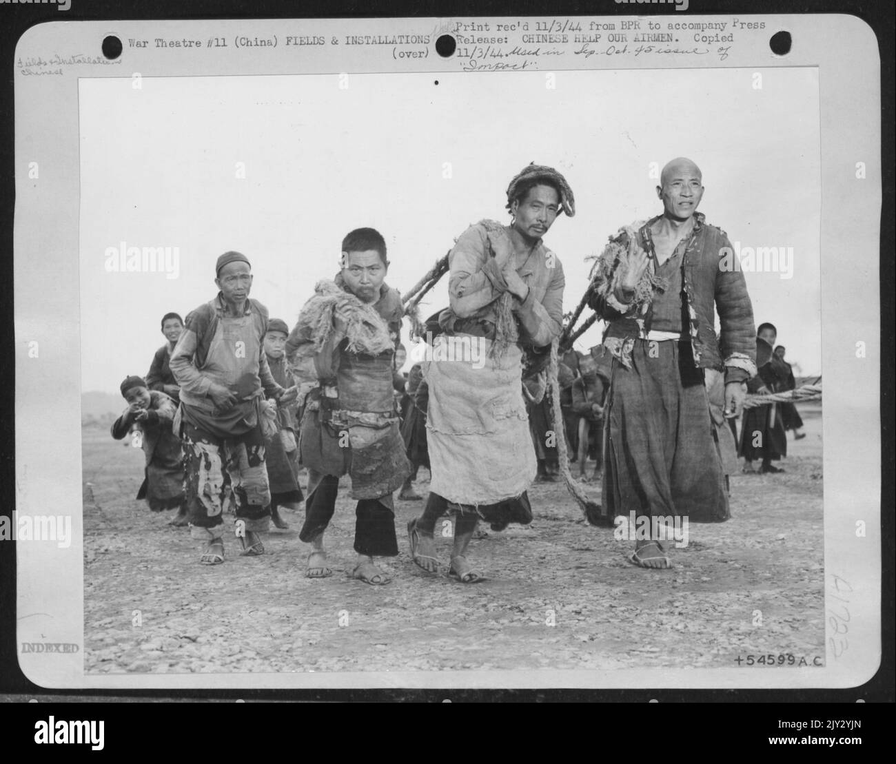 These Chinese are pulling a stone roller over a new strip being built ...