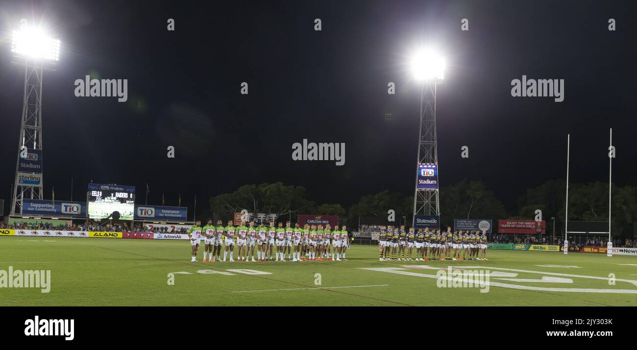 Teams line up arm in arm before the Round 15 NRL match between the ...