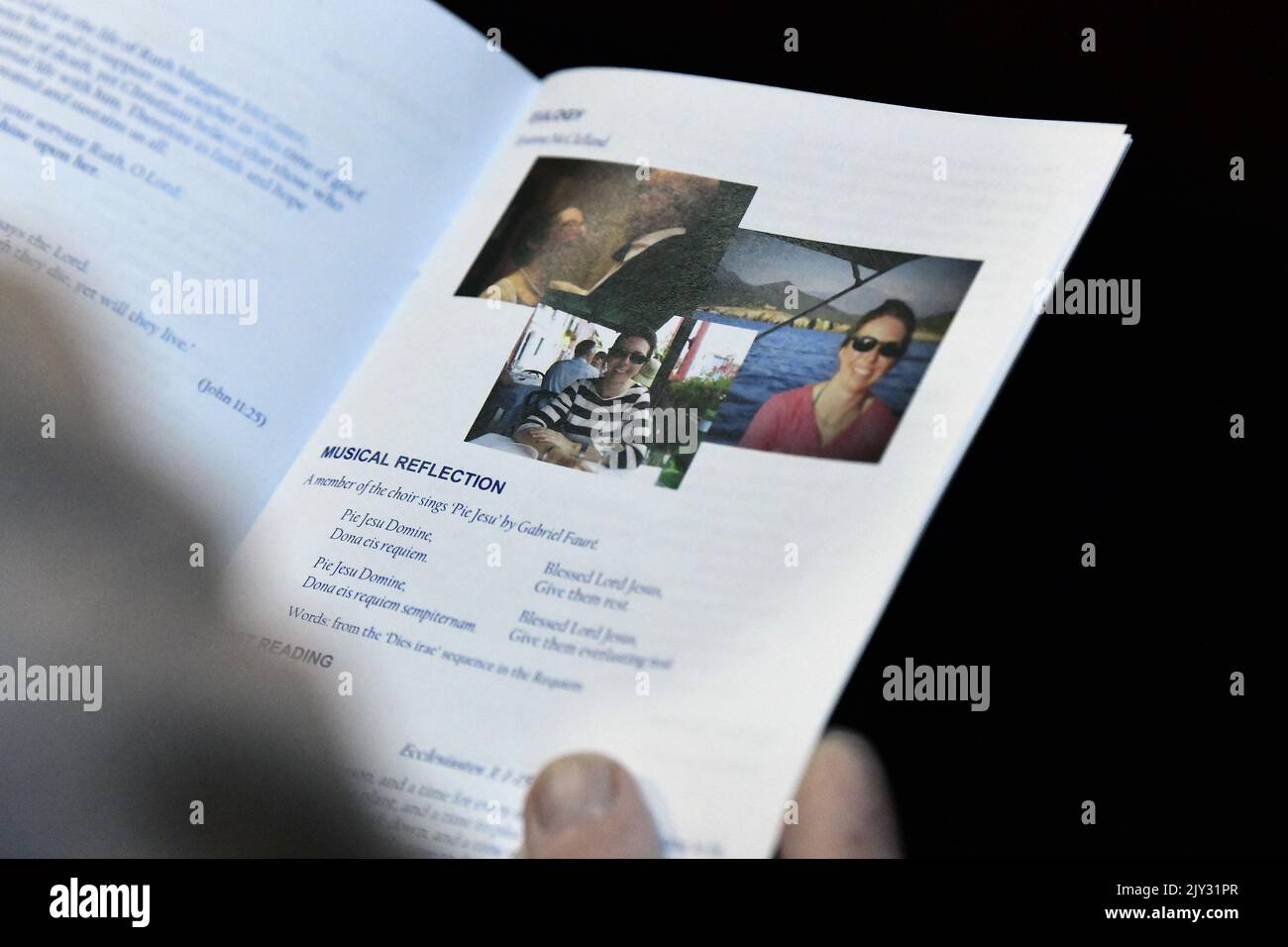 A mourner holds an order of service booklet during the Memorial Service ...