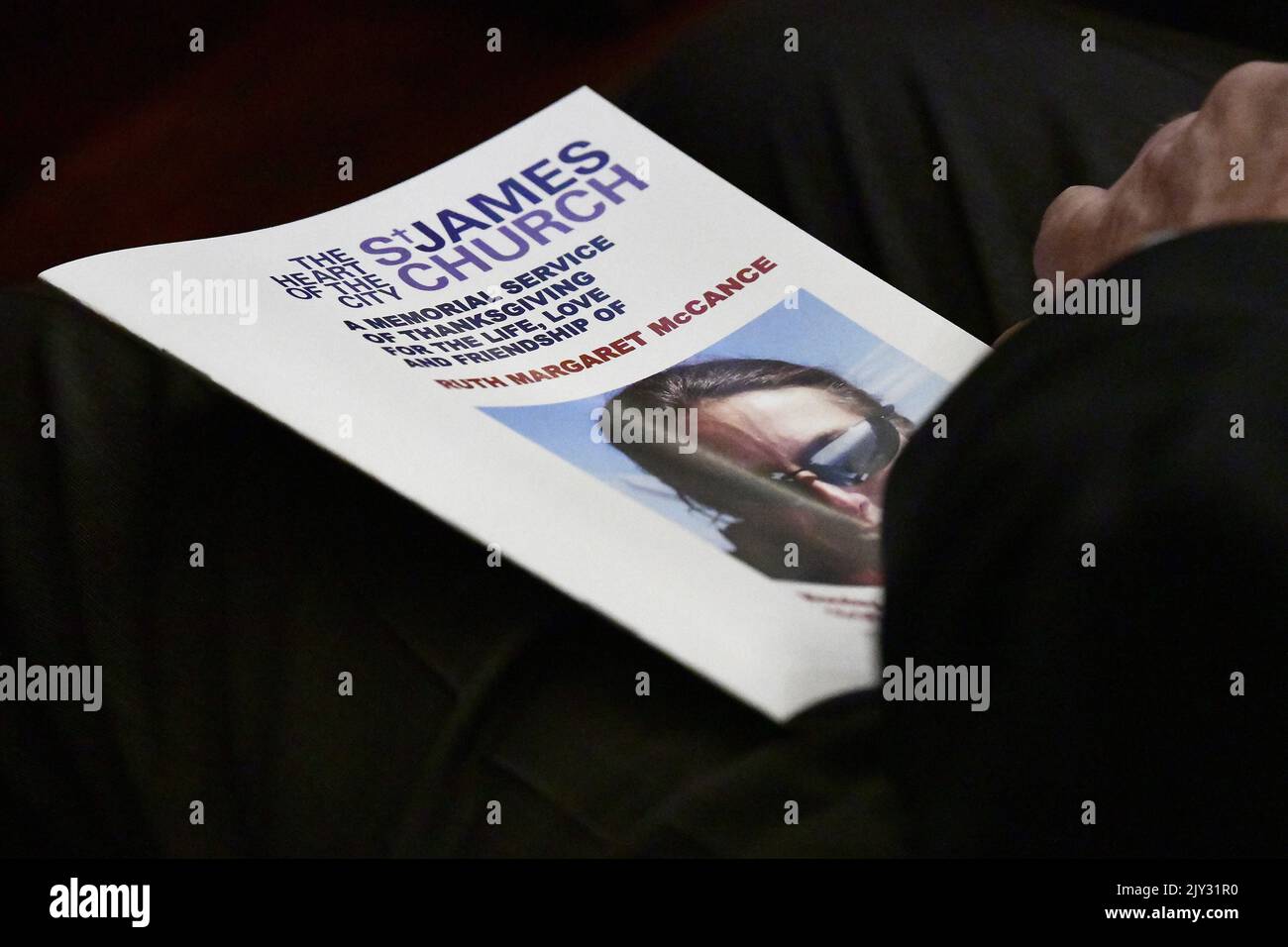 A mourner holds an order of service booklet during the Memorial Service ...