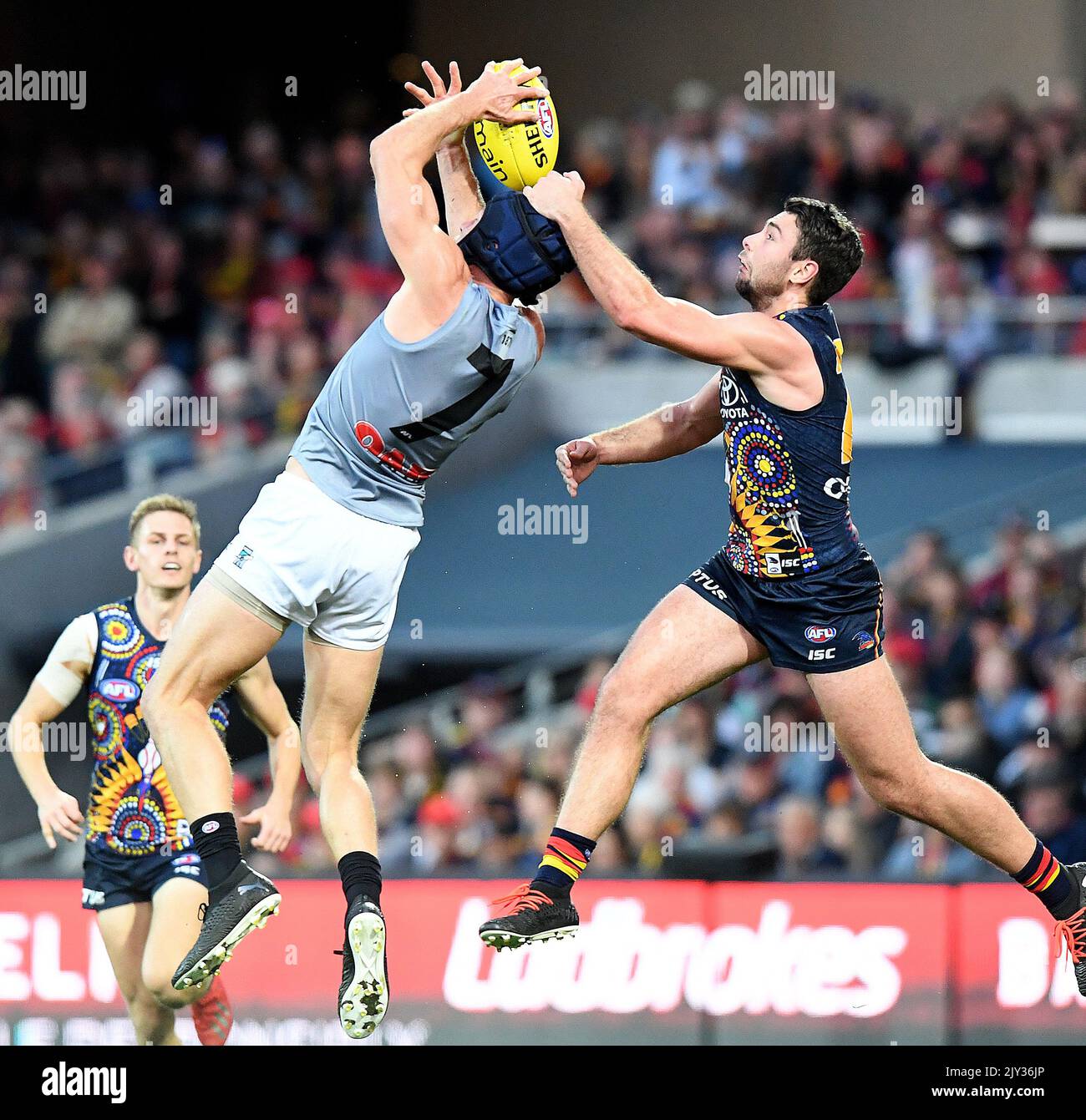 Brad Ebert of the Power and Rory Atkins of the Crows during the Round ...