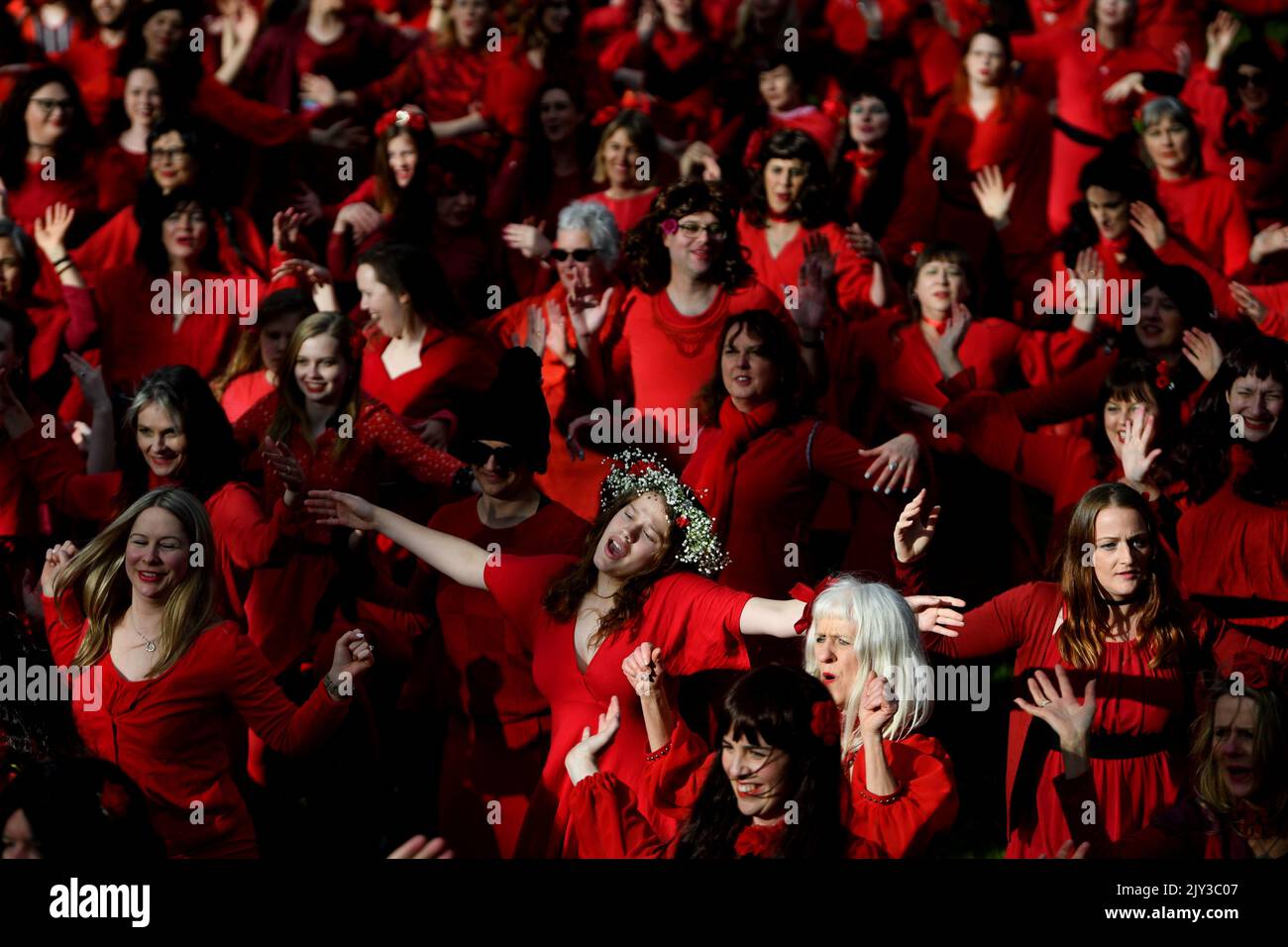 Kate Bush fans dressed in red dance as they recreate her film clip from ...