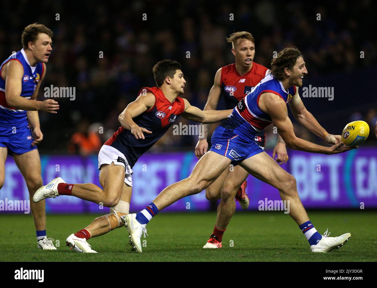 Marcus Bontempelli of the Bulldogs under pressure from Jay Lockhart of ...