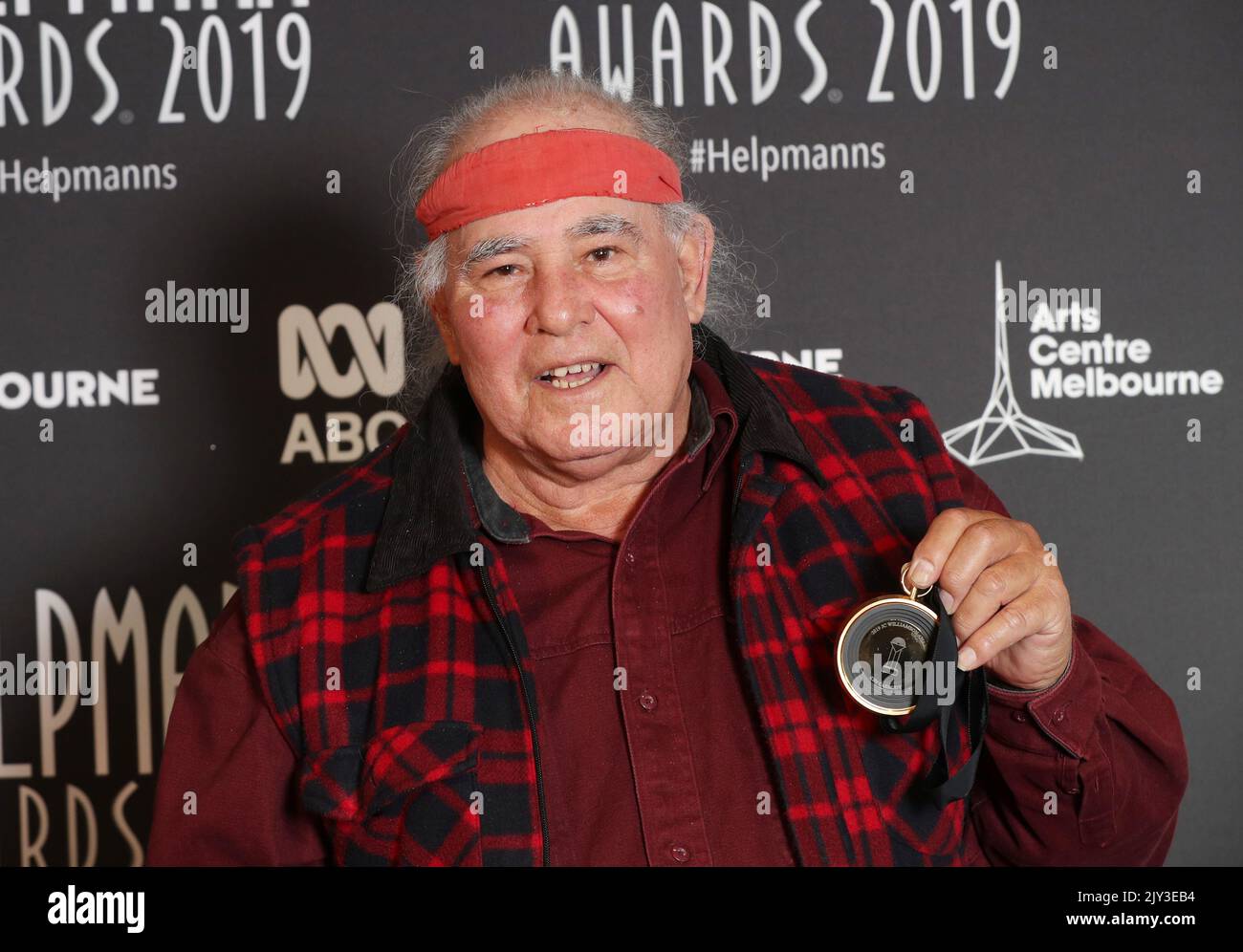 Kev Carmody poses for a photograph with the JC Williamson Award at the ...