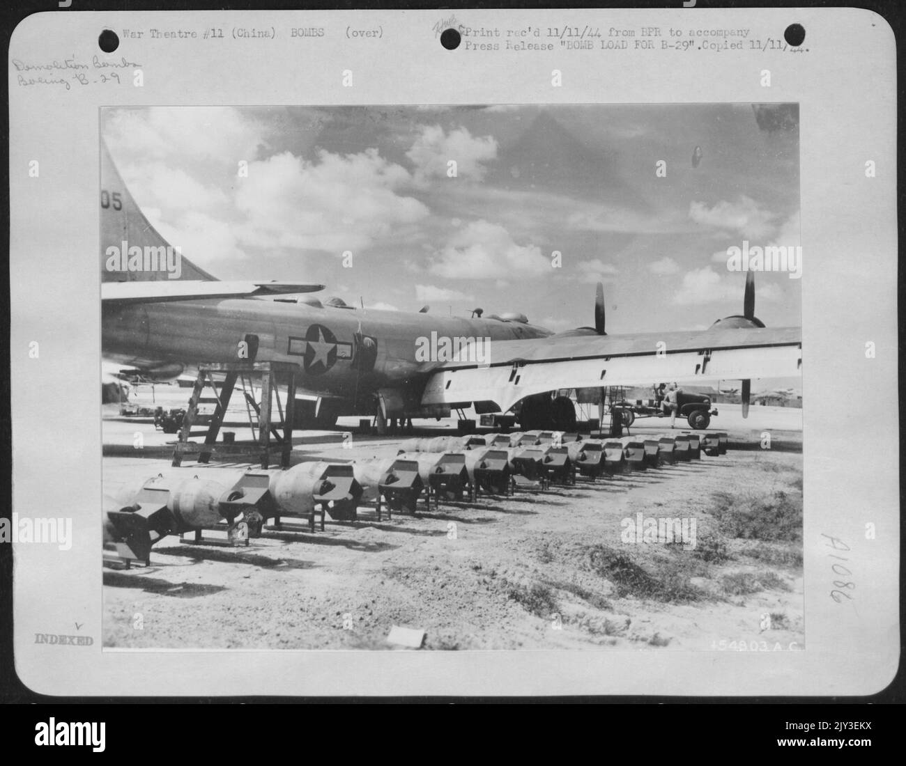 500-lb demolition bombs are lined up to be loaded into a B-29 which ...