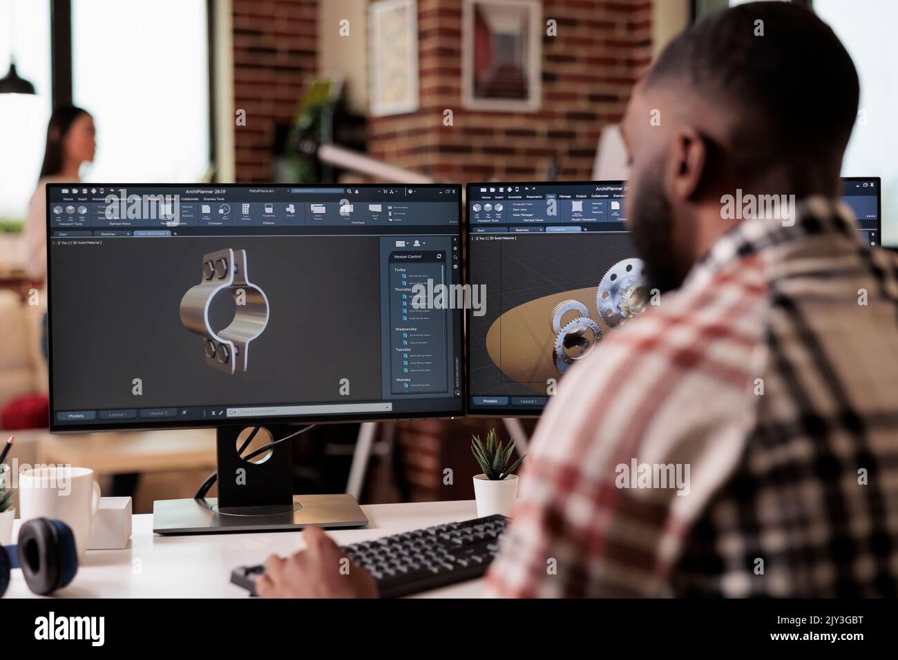 African american developer setting up gears model on manufacturing ...