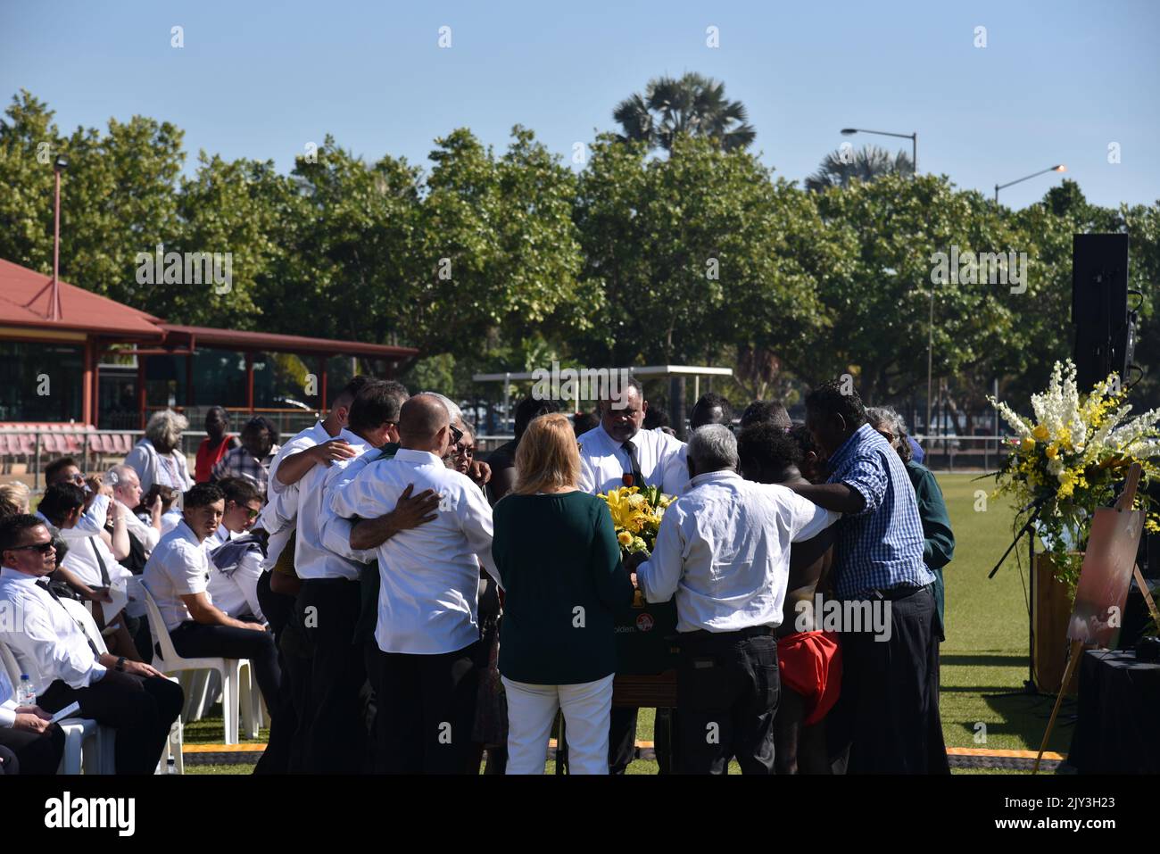 Mourners including former Essendon AFL champion Michael Long, are seen ...
