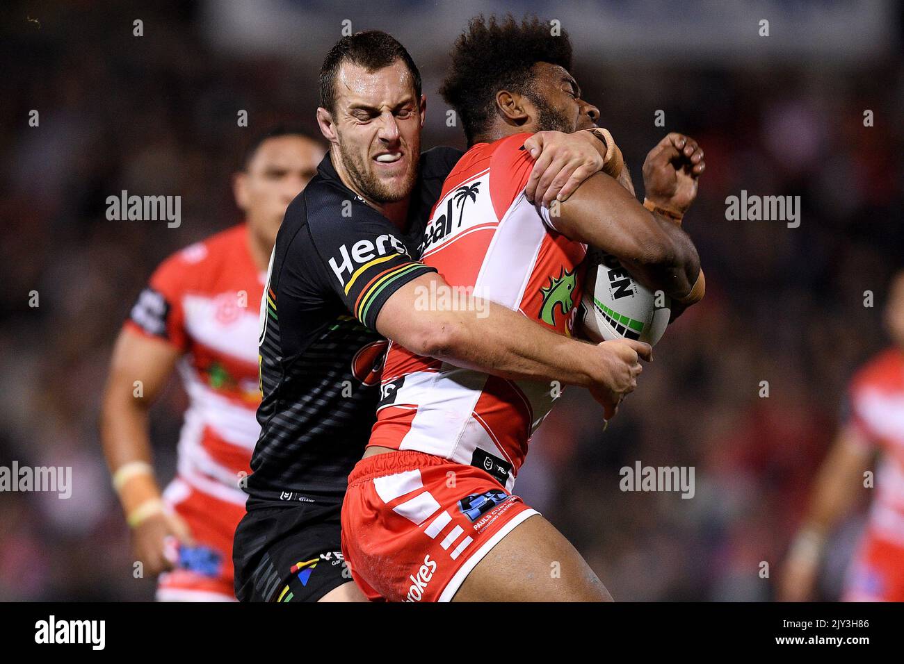 Mikaele Ravalawa of the Dragons is tackled by Isaah Yeo of the Panthers ...