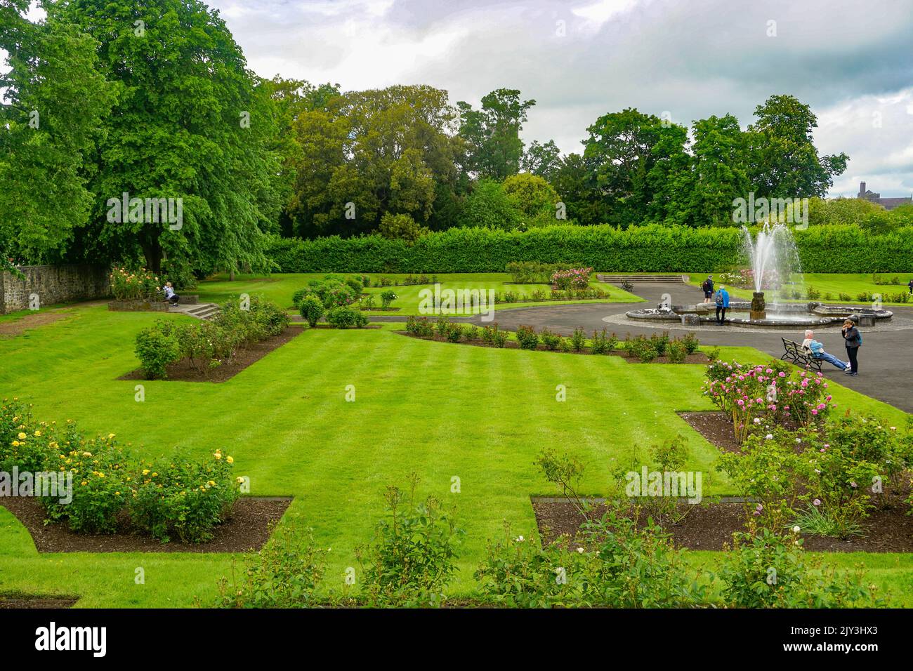 Kilkenny, Ireland: Tourists relaxing in the garden at Kilkenny Castle ...