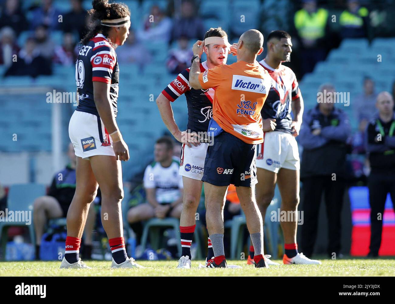 Luke Keary of the Roosters has his head bandaged during the Round 18 ...