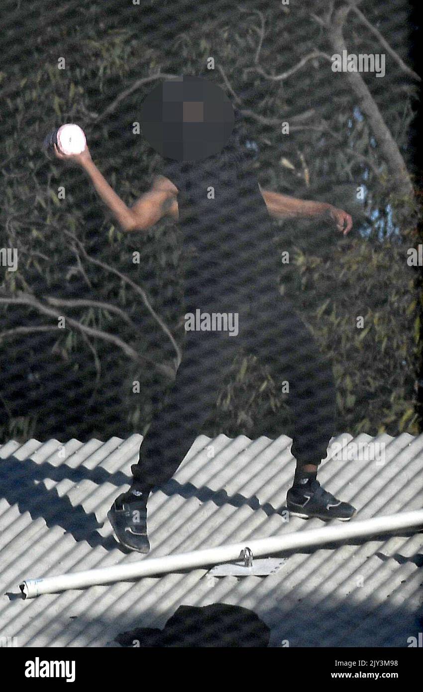 A detainee throws an object during a riot at the Frank Baxter Juvenile Justice Centre, Kariong ...