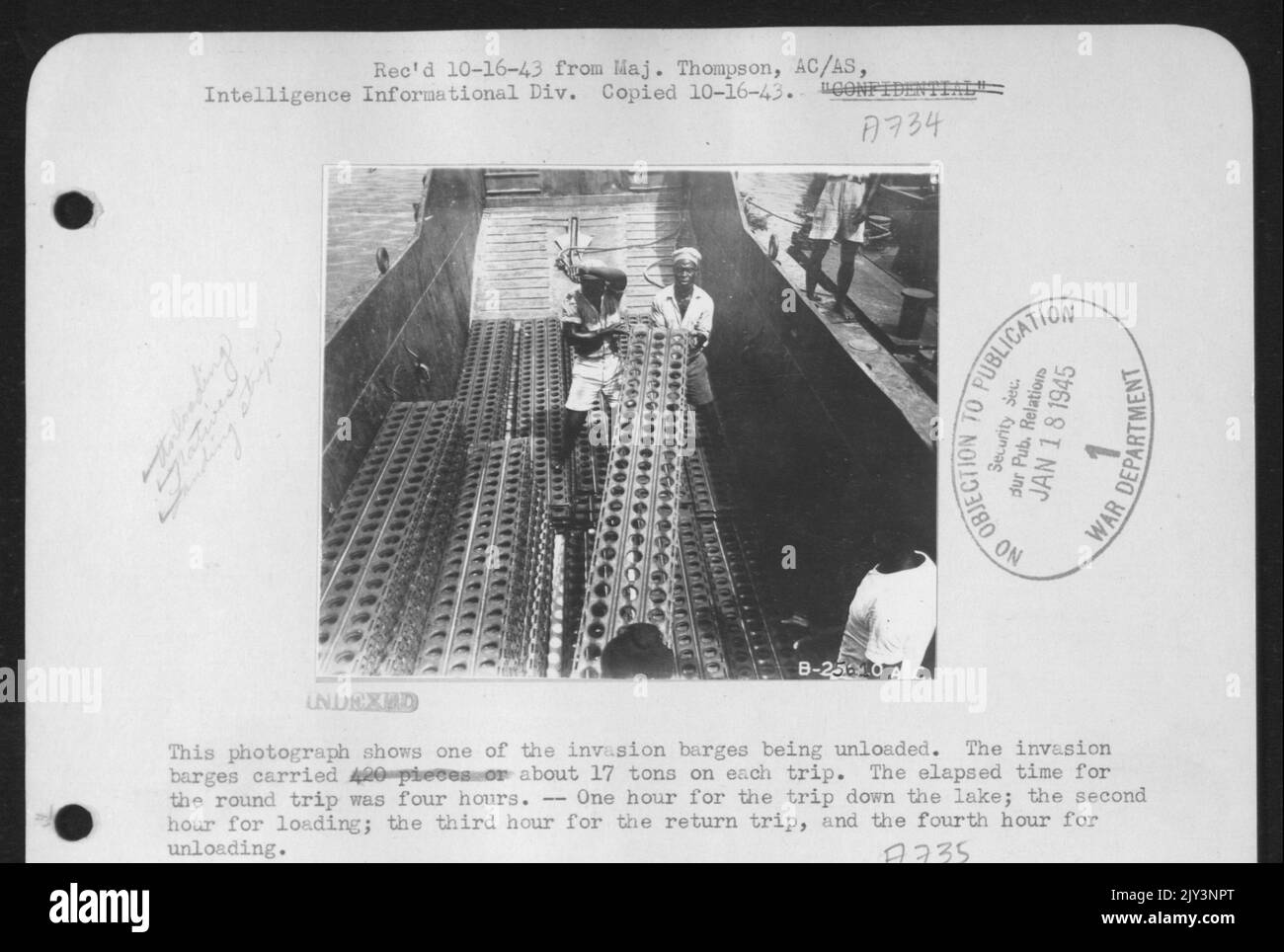 This photograph shows one of the invasion barges being unloaded which ...