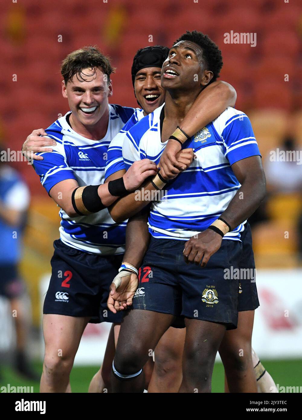 Lastus Auakai of Nudgee College (right) celebrates scoring a try with ...
