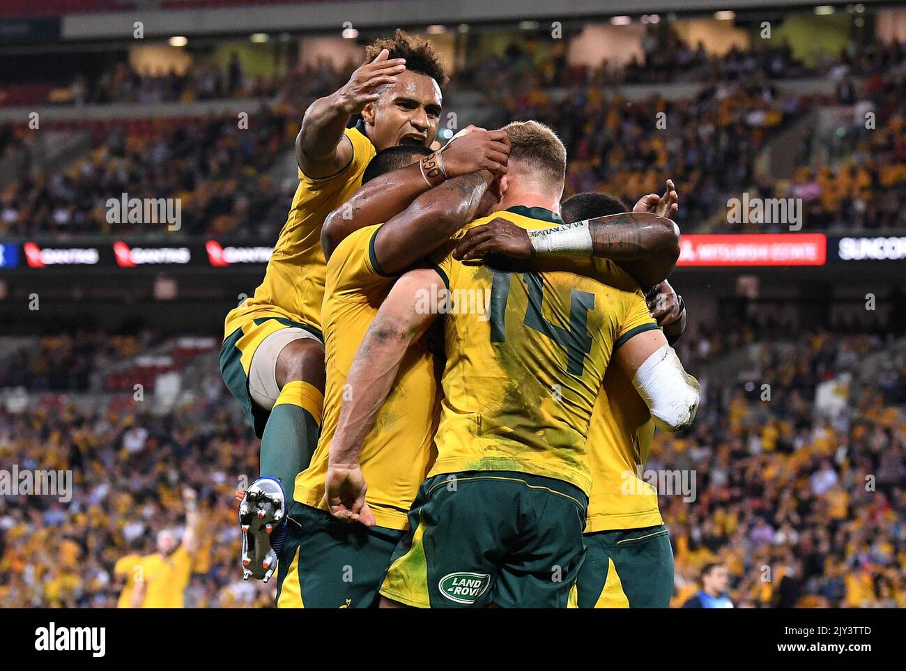 Will Genia of the Wallabies (left) celebrates a try with teammates ...
