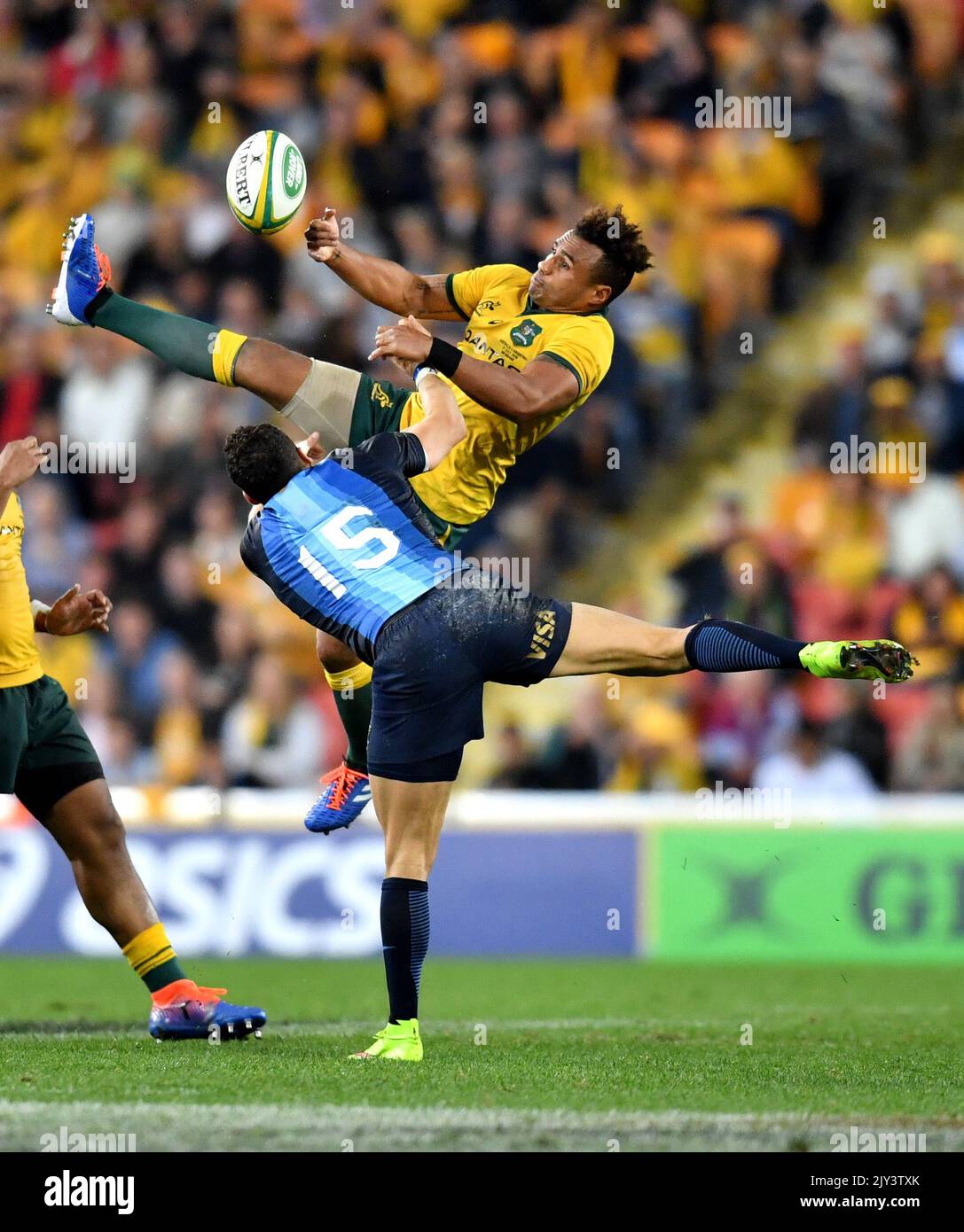 Will Genia of the Wallabies flies for the ball over Joaquin Tuculet of ...