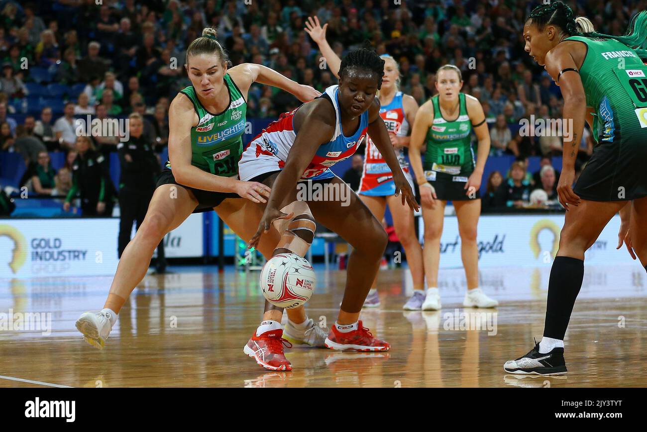 Sam Wallace of the Swifts battles for the ball with Courtney Bruce of ...