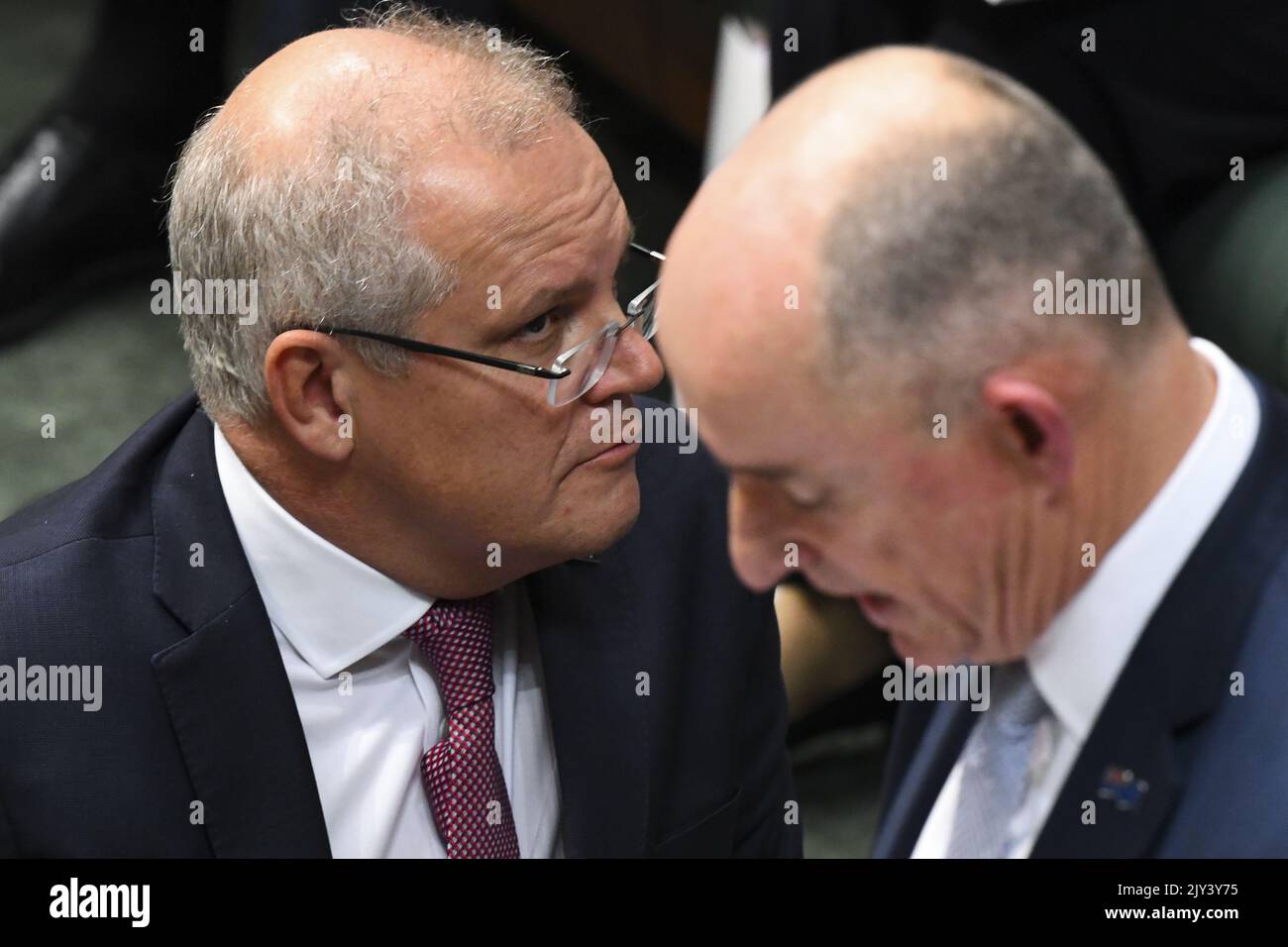 Australian Prime Minister Scott Morrison (left) listens to Australian ...