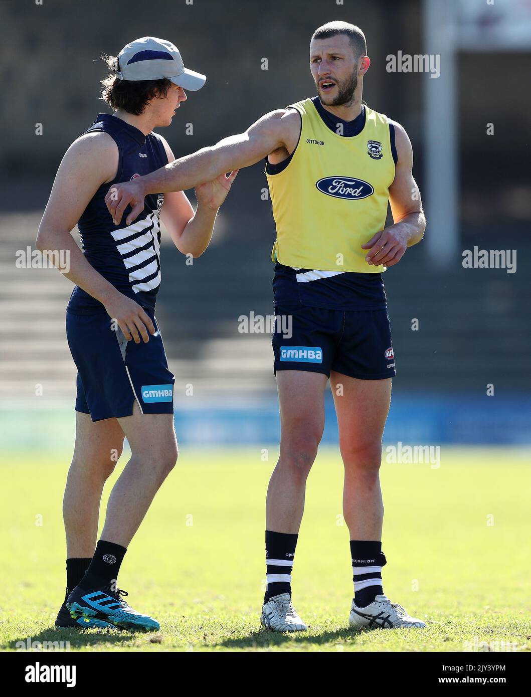 Sam Menegola speaks to Jordan Clark during a Geelong Cats training ...
