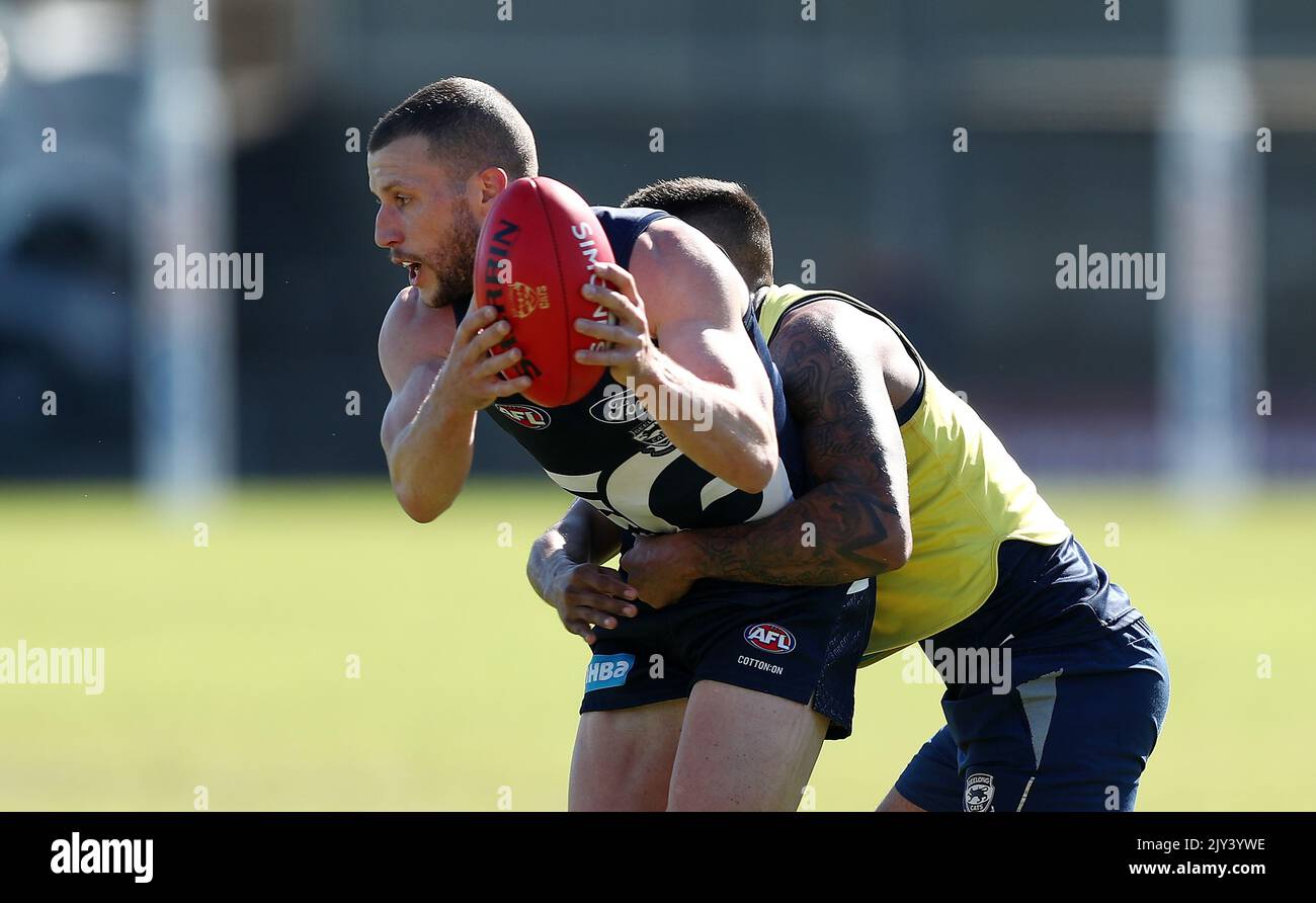 Sam Menegola is tackled by Tim Kelly during a Geelong Cats training ...