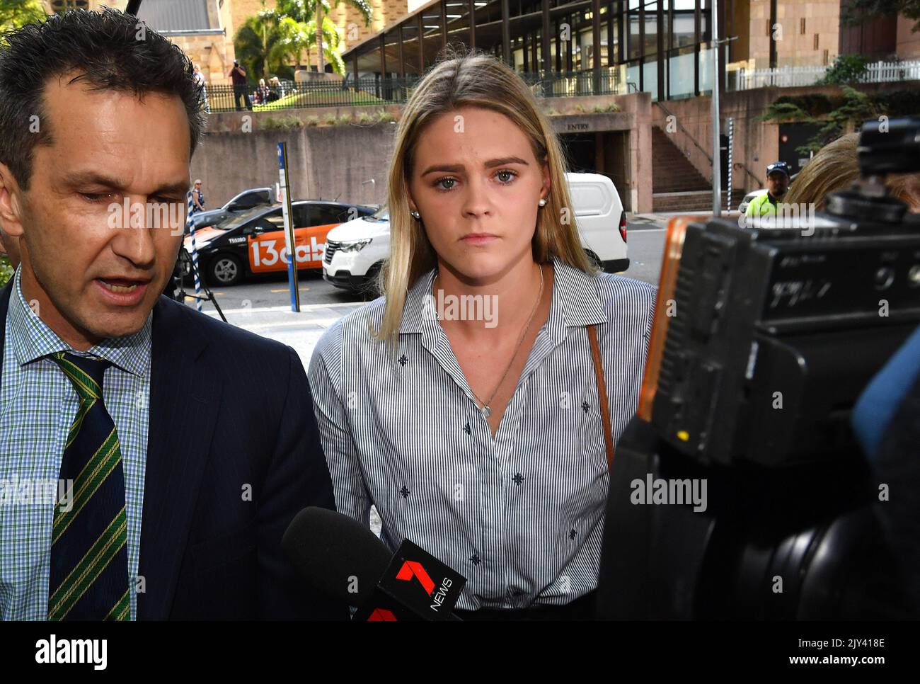 Australian swimmer Shayna Jack (centre) is seen arriving for a briefing ...