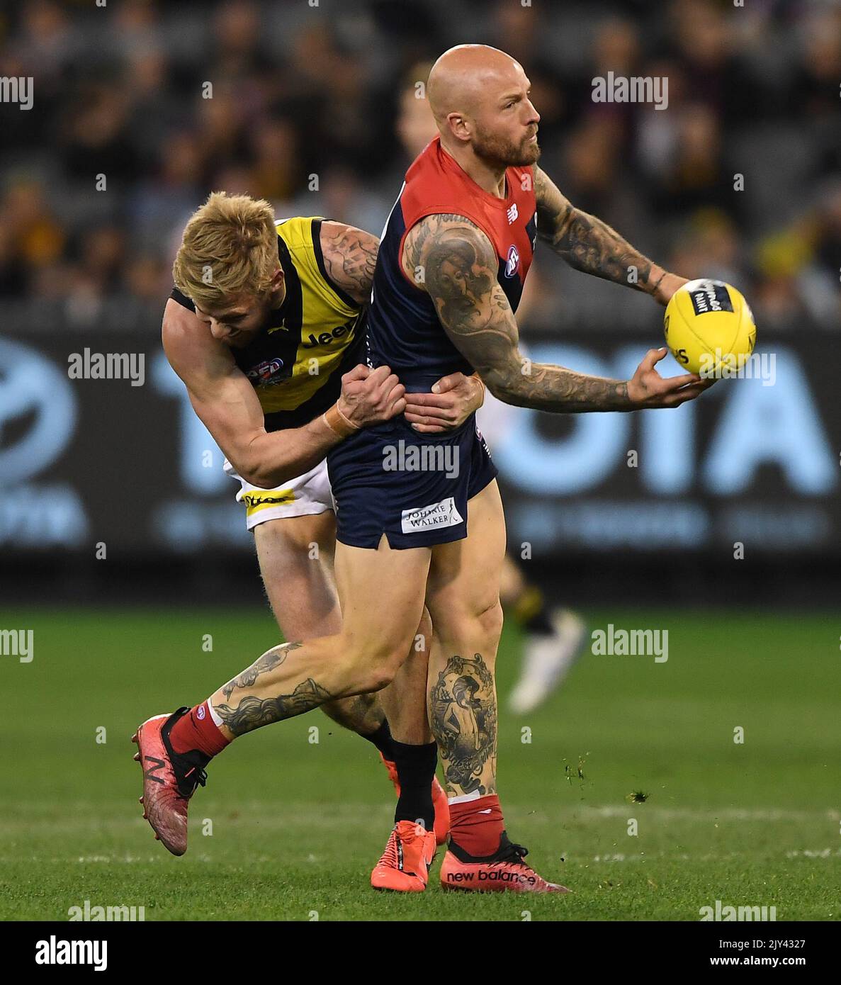 Nathan Jones of the Demons (right) and Nathan Broad of the Tigers ...