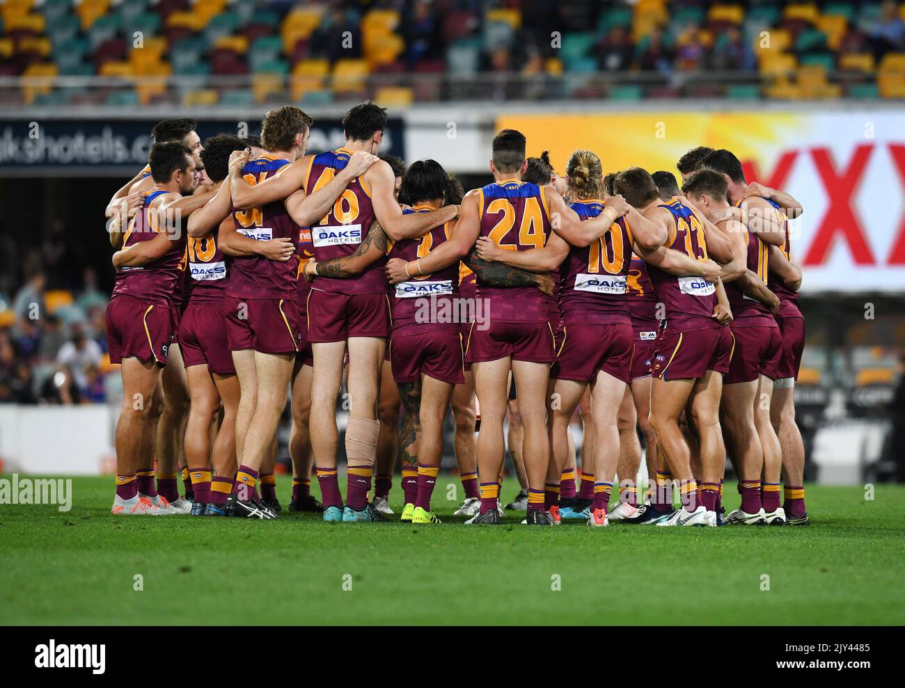 Lions players huddle during the Round 20 AFL match between the Brisbane ...