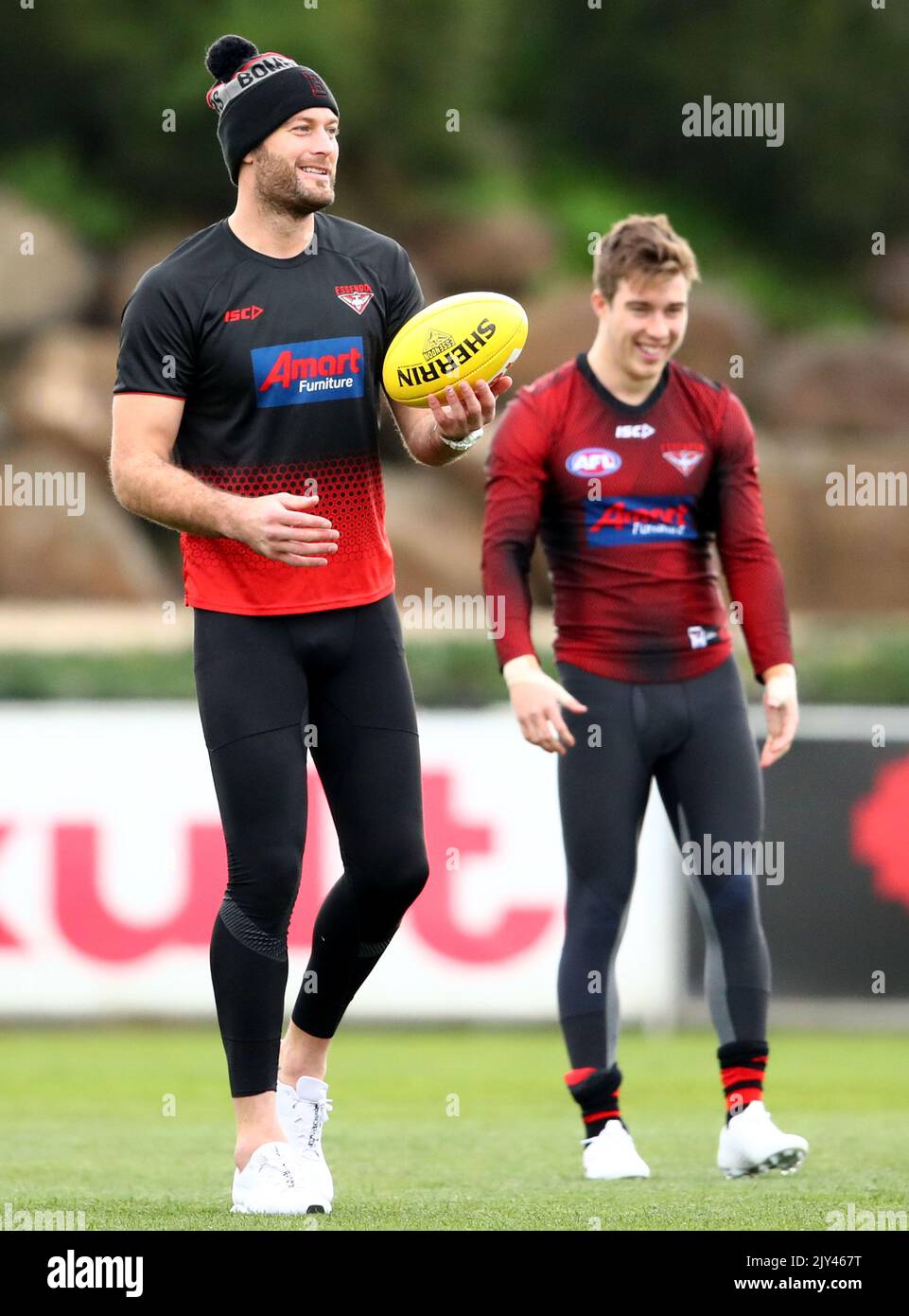 Tom Bellchambers of the Bombers and Zach Merrett of the Bombers look on ...