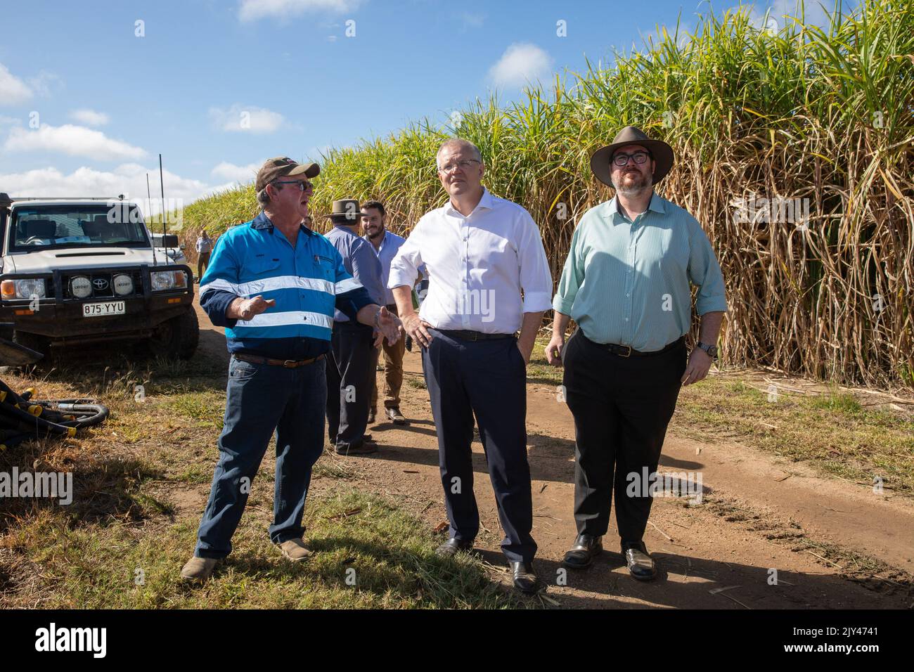 Prime Minister Scott Morrison (centre) and MP George Christensen meet with harvesting contractor ...