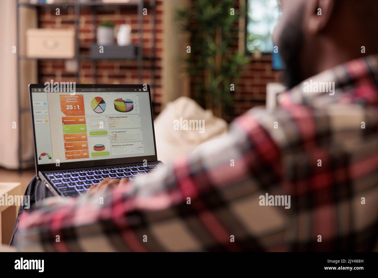 Business man analyzing charts on laptop, working on remote startup job ...