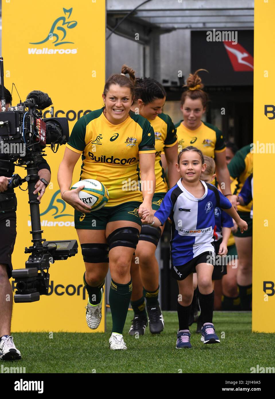 Grace Hamilton of the Wallaroos leads the team out during the ...