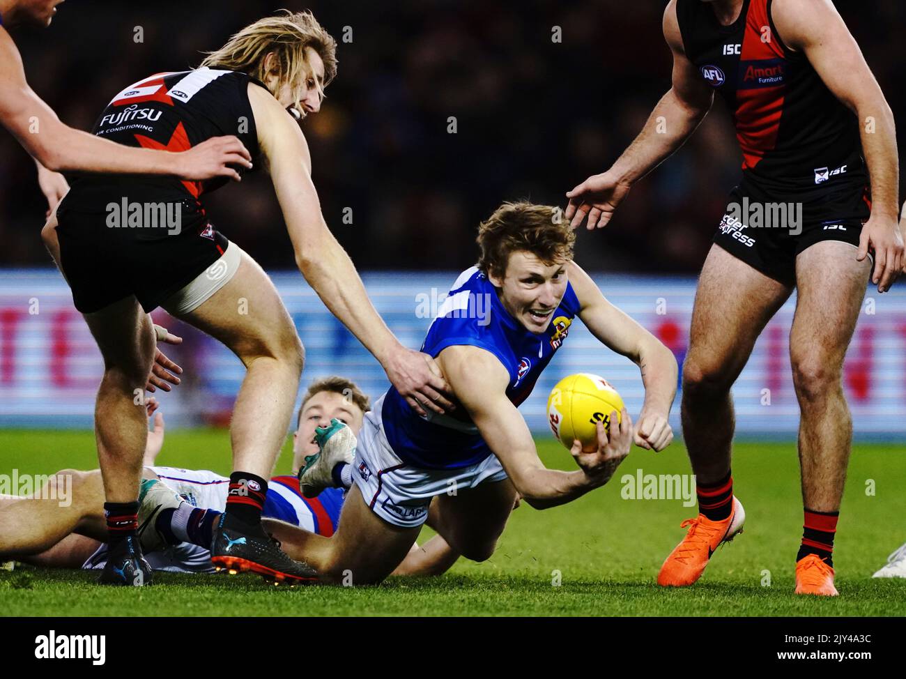 Bailey Dale of the Bulldogs handballs during the Round 21 AFL match ...