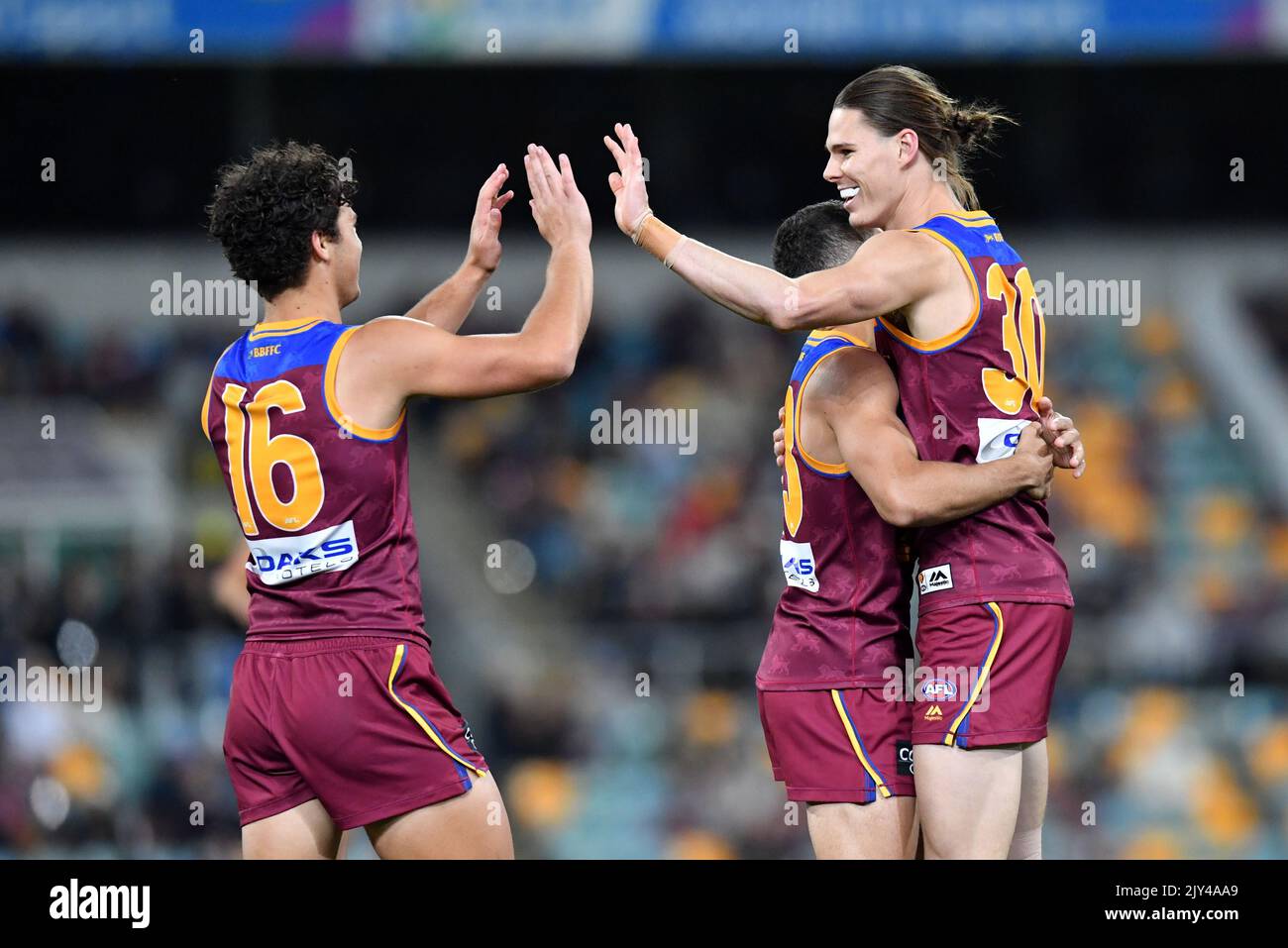 Eric Hipwood (right) of the Lions celebrates kicking a goal with ...
