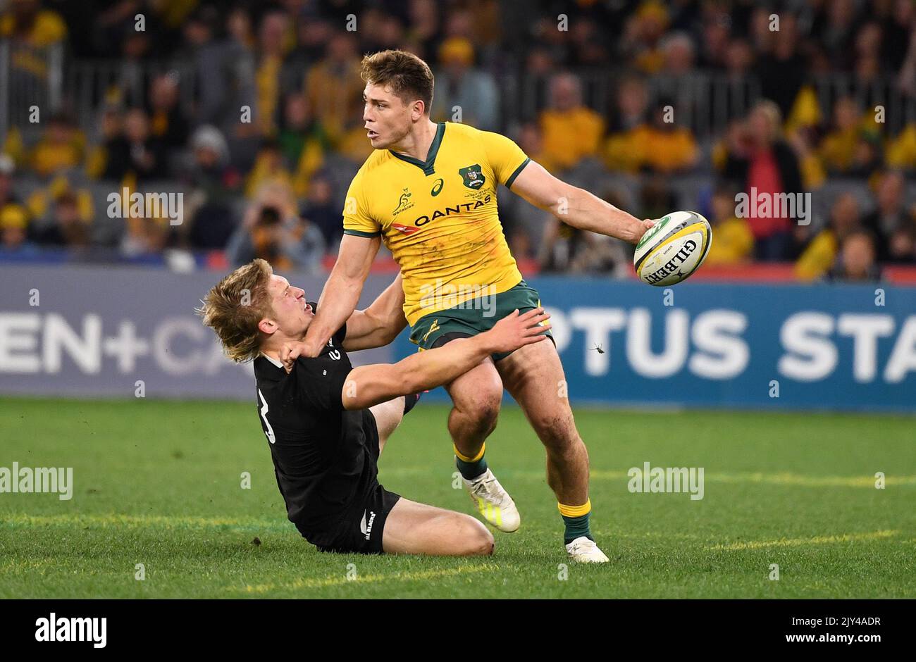 Jack Goodhue of the All Blacks attempts to tackle James O'Connor of the ...