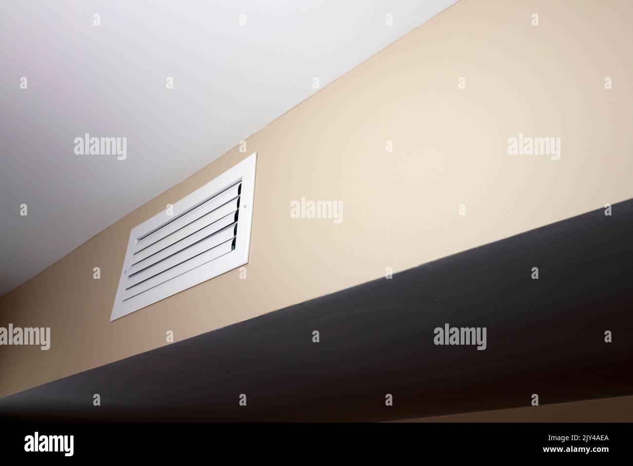 One closed air vent that is rectangle, white, small and situated in a ...
