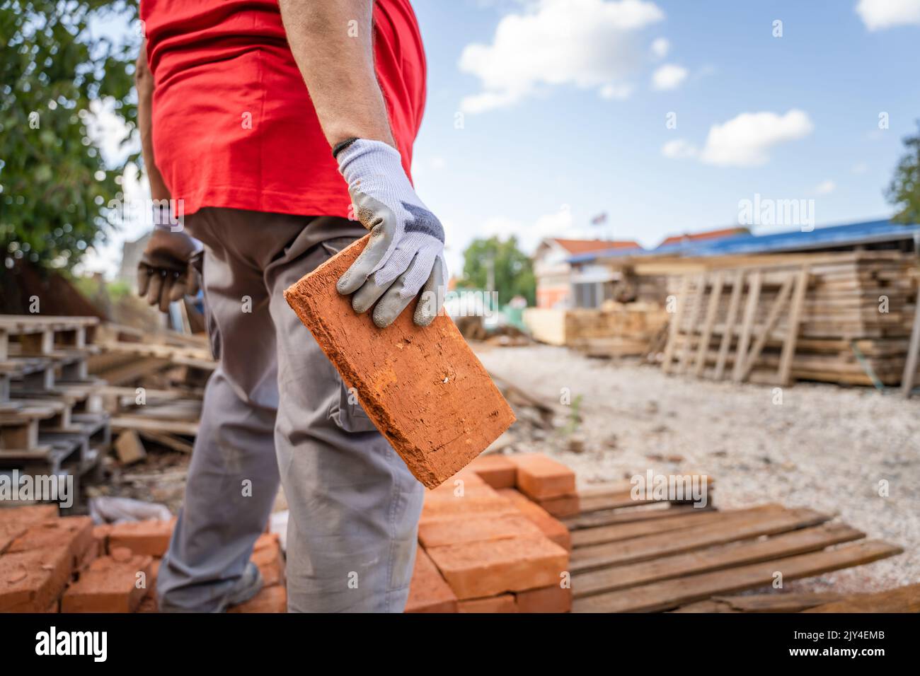 Construction worker carrying bricks hi-res stock photography and images ...
