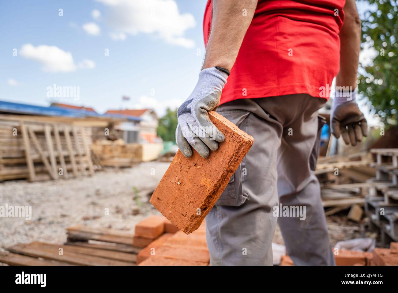 Construction worker carrying bricks hi-res stock photography and images ...