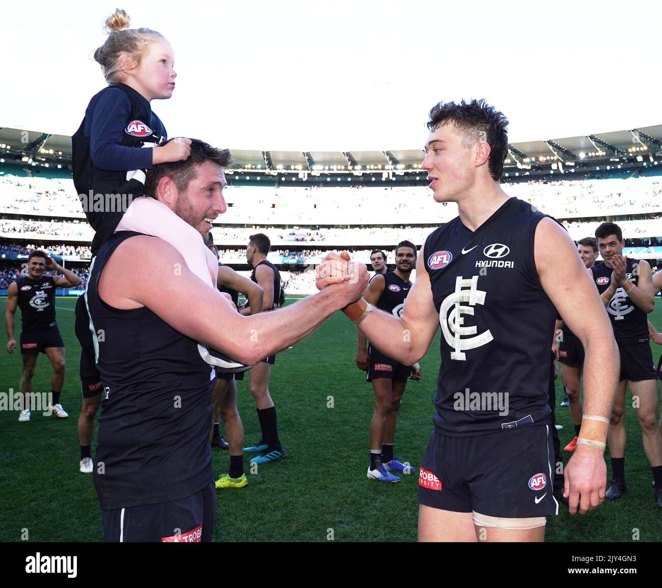 Retiring Dale Thomas of the Blues celebrates the win with his daughter ...