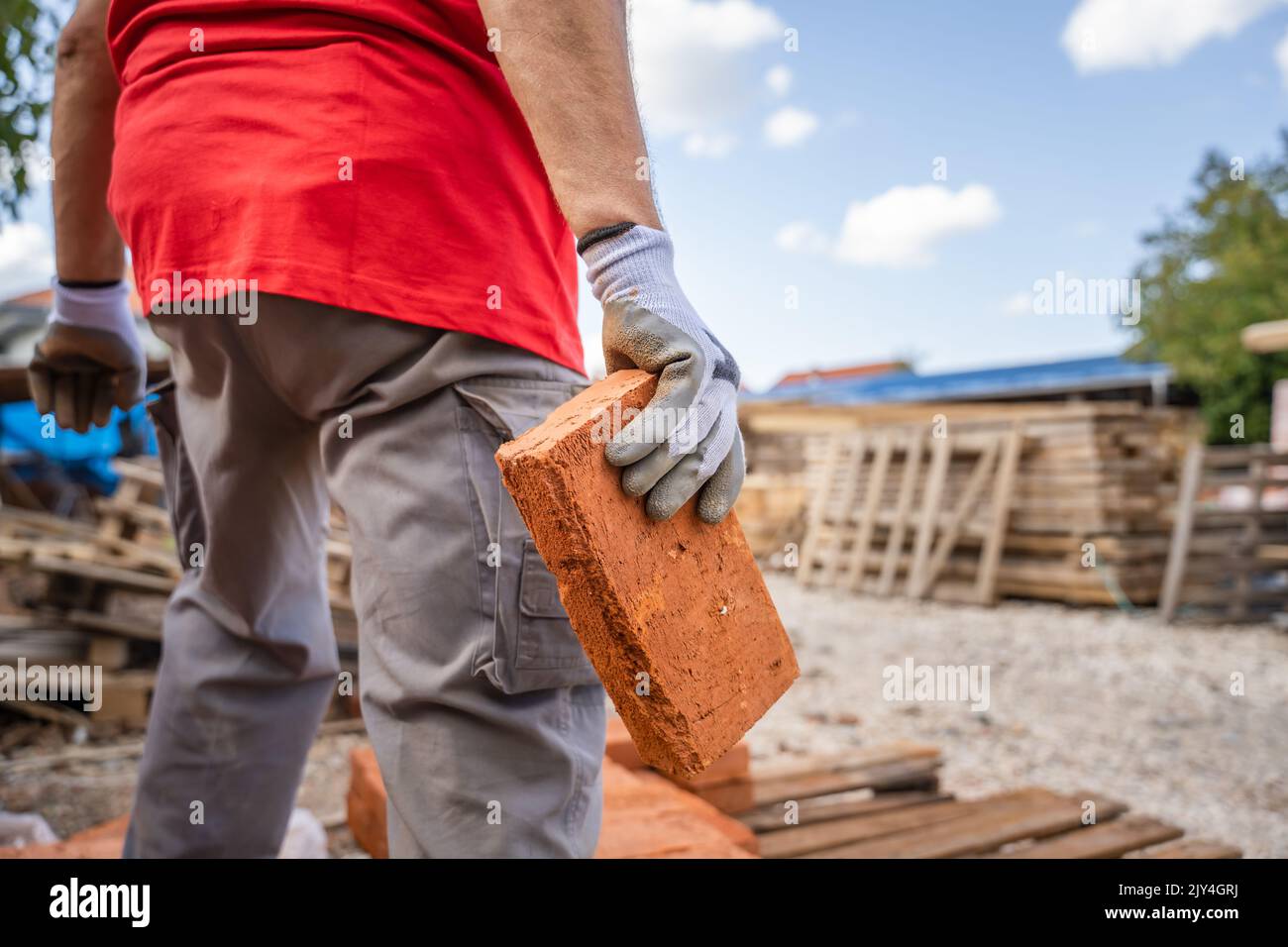 Construction worker carrying bricks hi-res stock photography and images ...