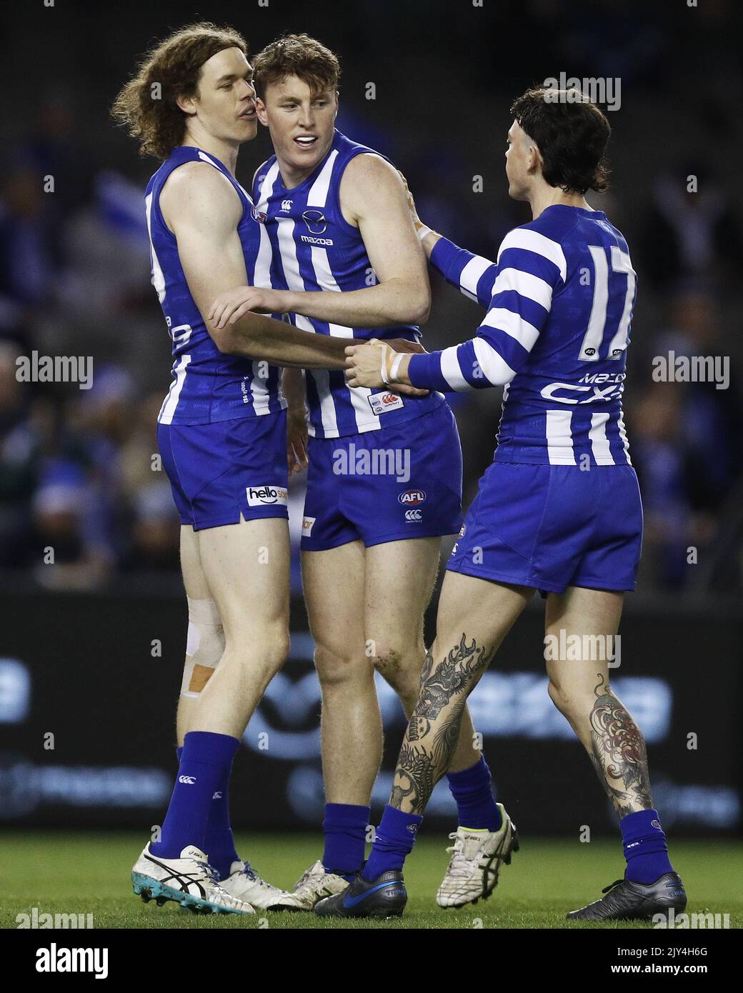 Nick Larkey of the Kangaroos (centre) celebrates a goal with teammates ...
