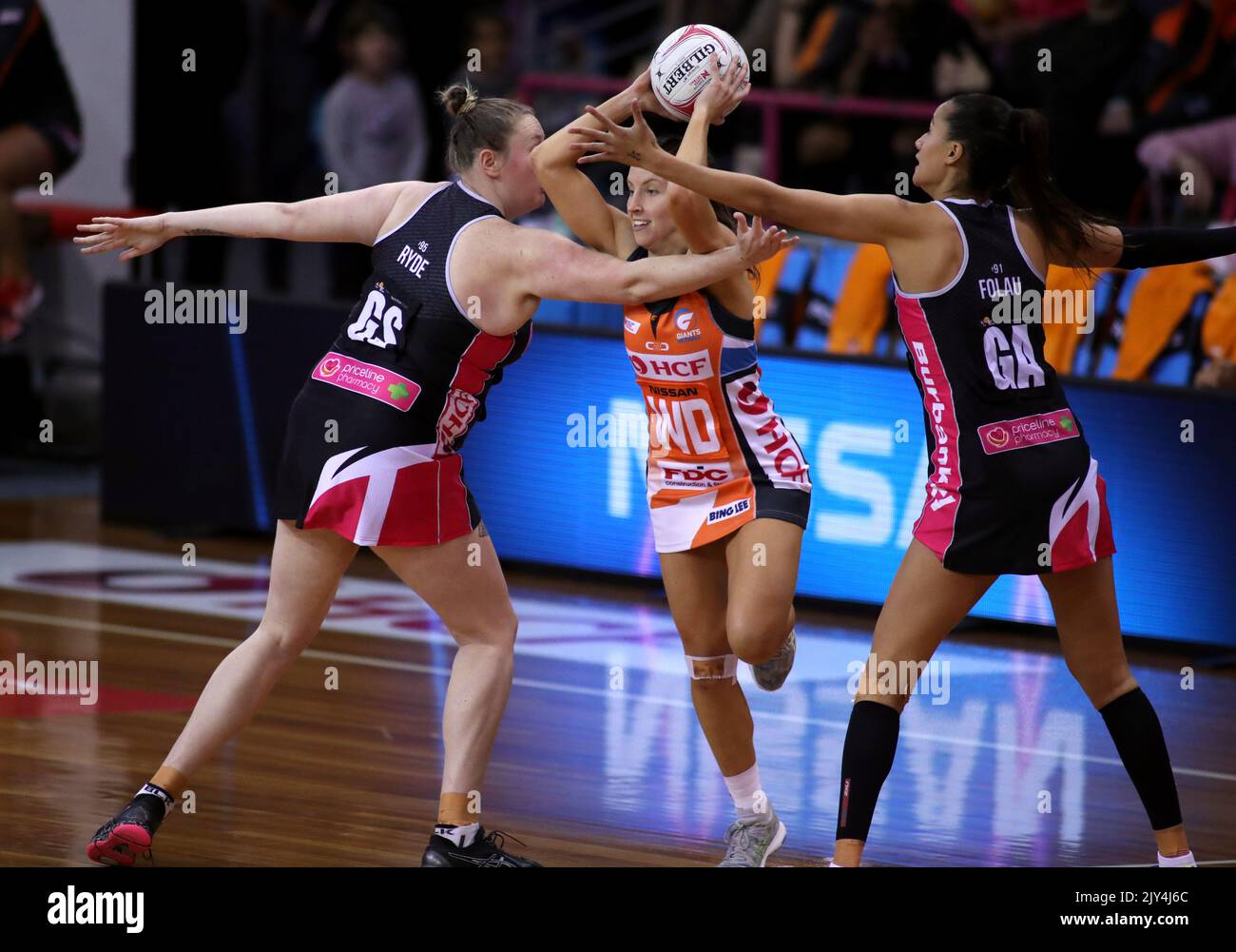 Amy Paramenter of the Giants breaks past Emma Ryde and Maria Folau of ...