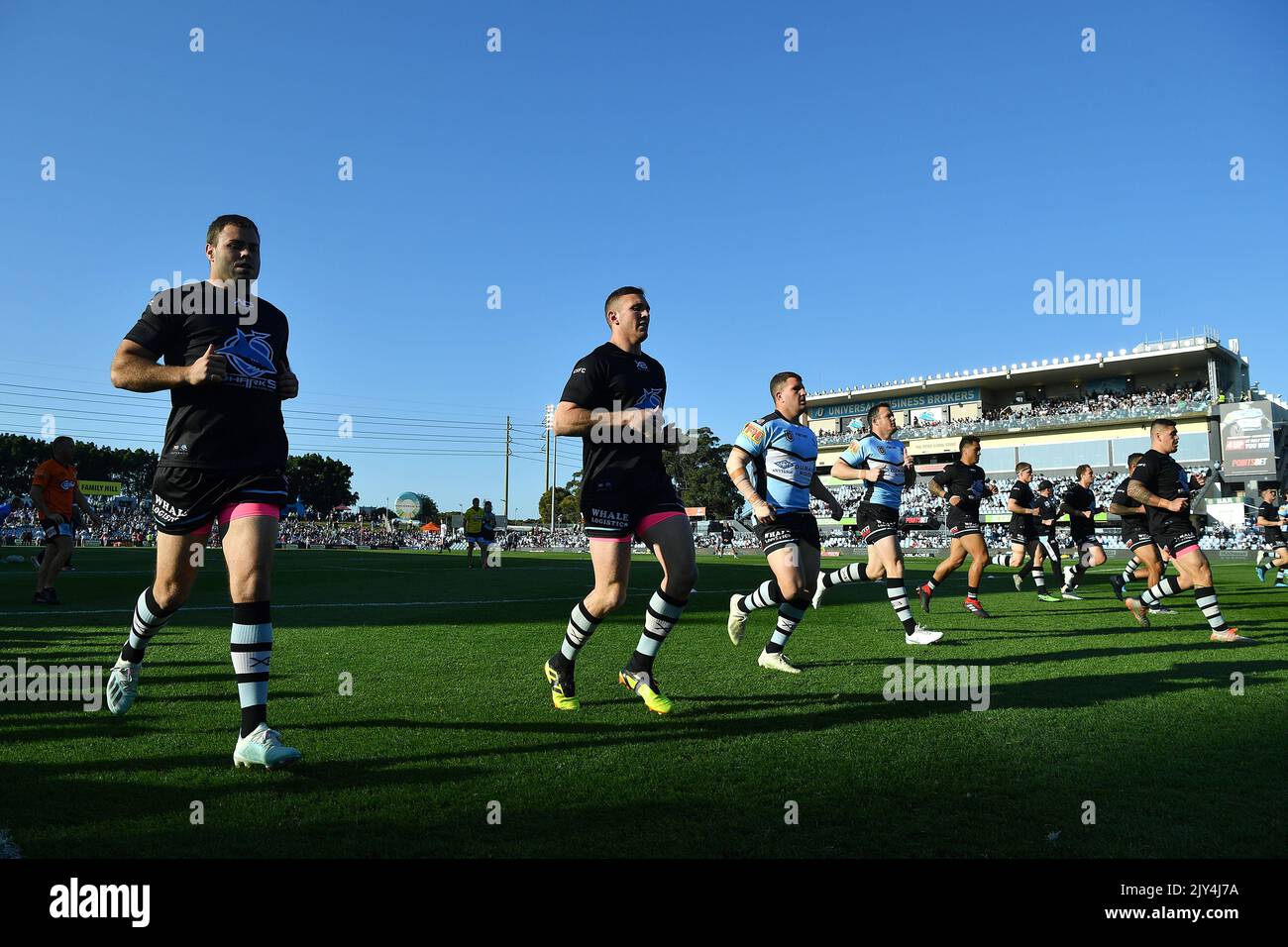 Sharks players warm up during the Round 22 AFL match between the ...