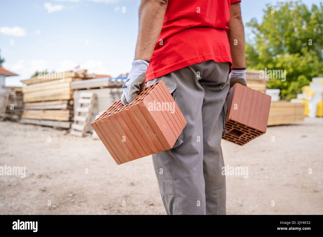 Construction worker carrying bricks hi-res stock photography and images ...