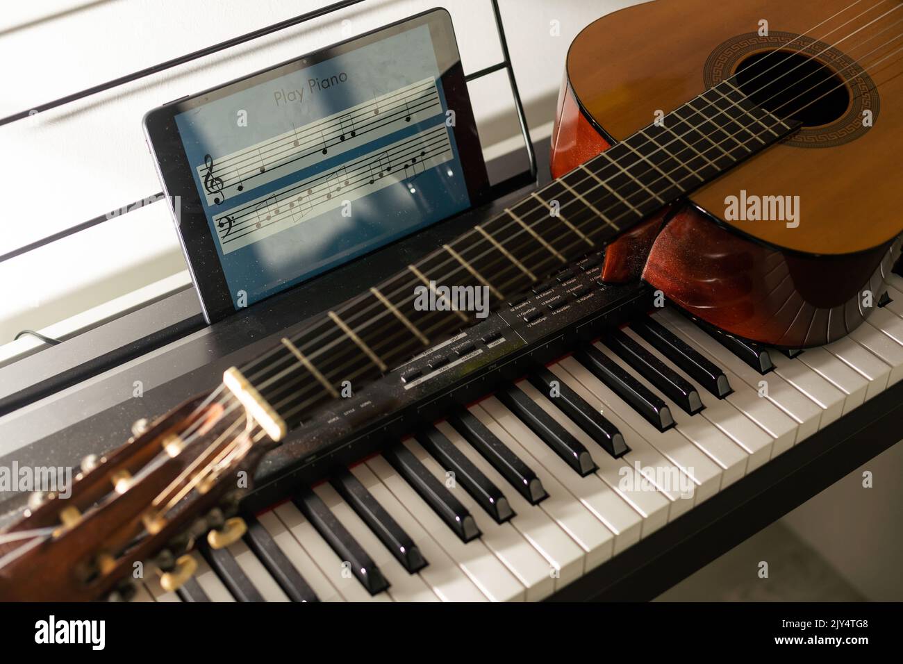 piano keyboard and guitar. tablet Stock Photo - Alamy