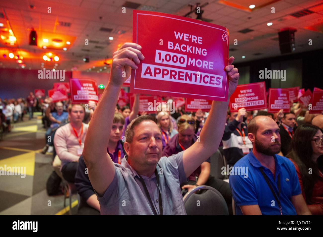 Delegates are seen holding signs during the Queensland Labor State ...