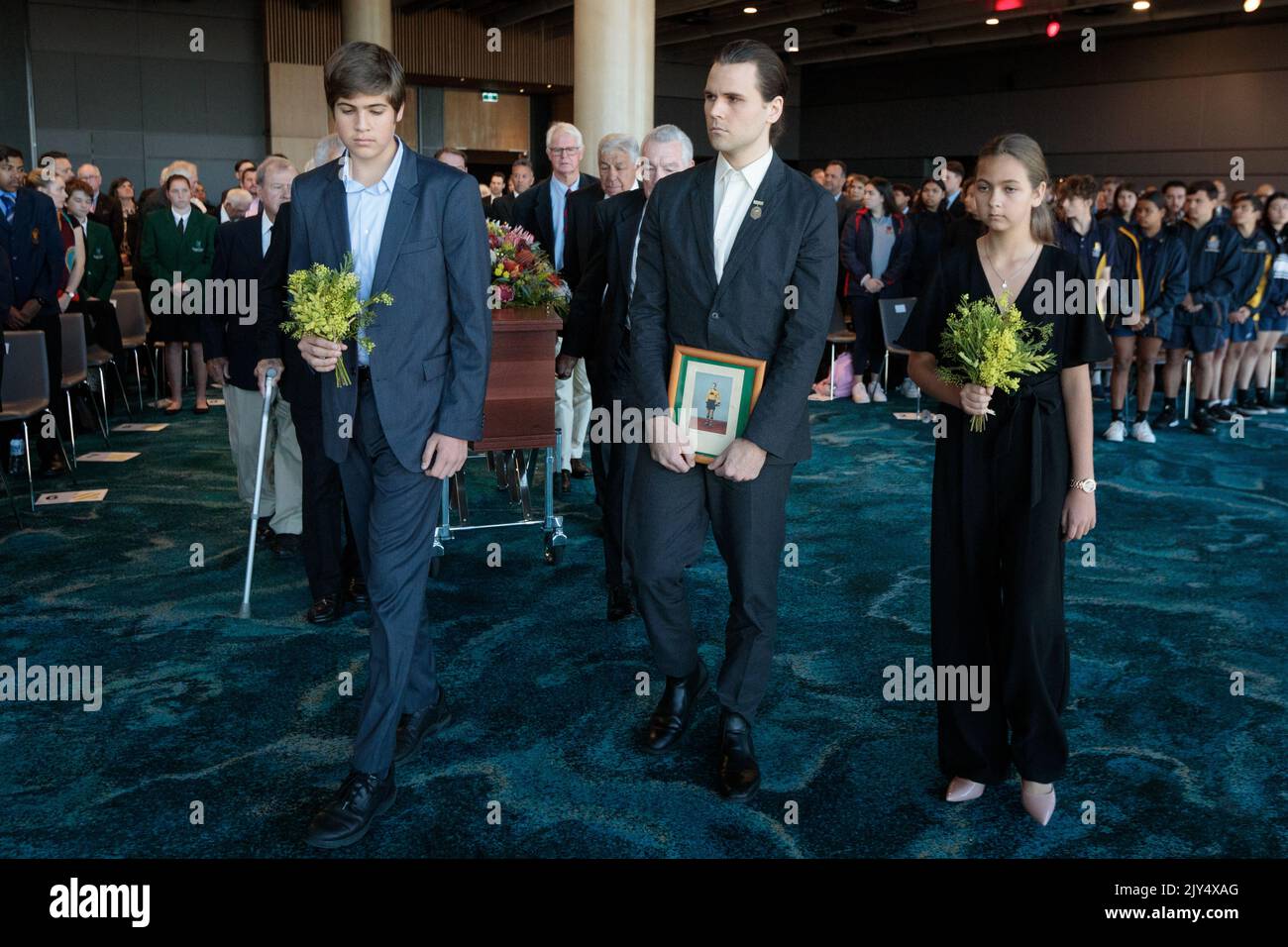 (L-R) Pallbearers Chilli Farmer, Cole Baxter and Ruby Farmer are seen ...