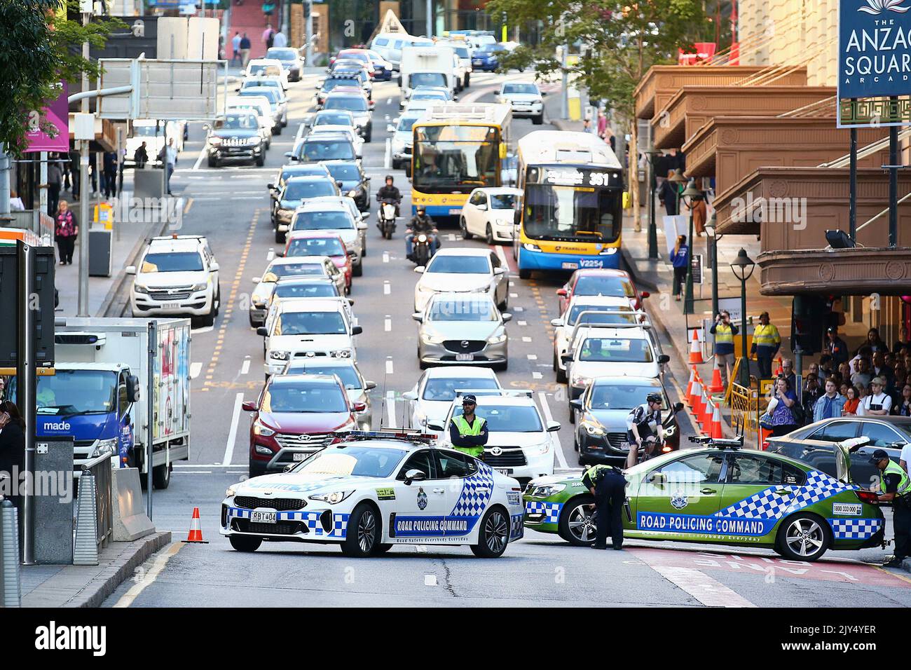 Qld Police vehicles barricade traffic as a protest makes its way ...