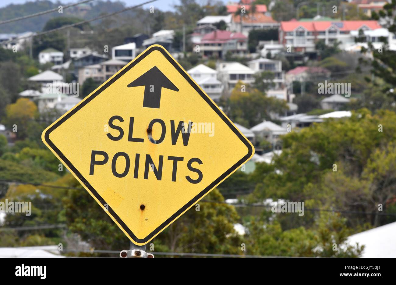 Houses and apartment buildings are seen behind a road sign in the ...