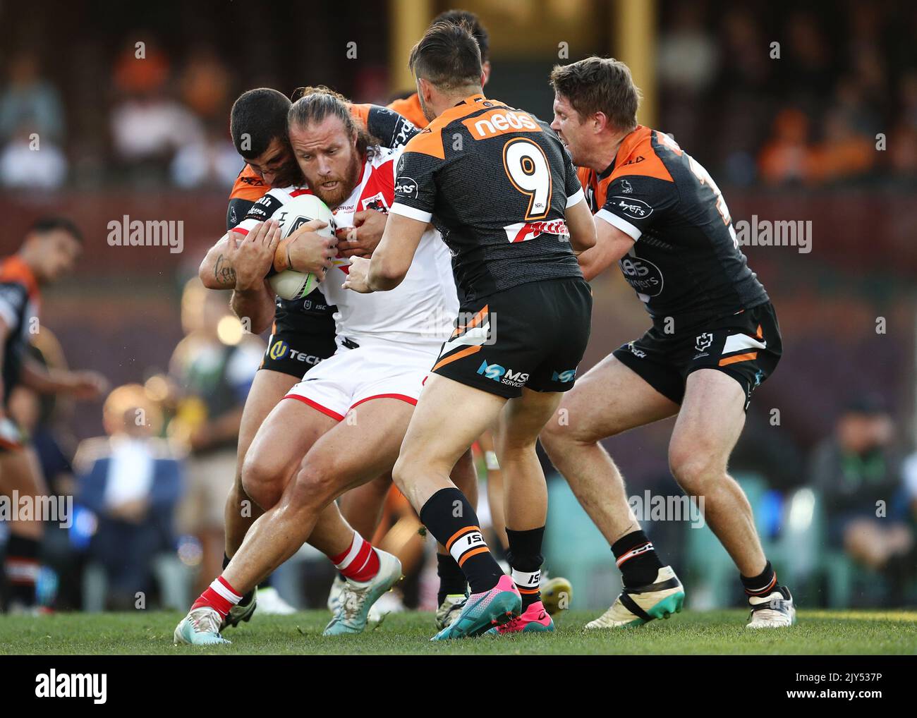 Korbin Sims of the Dragons is tackled by the Tigers defence during the ...
