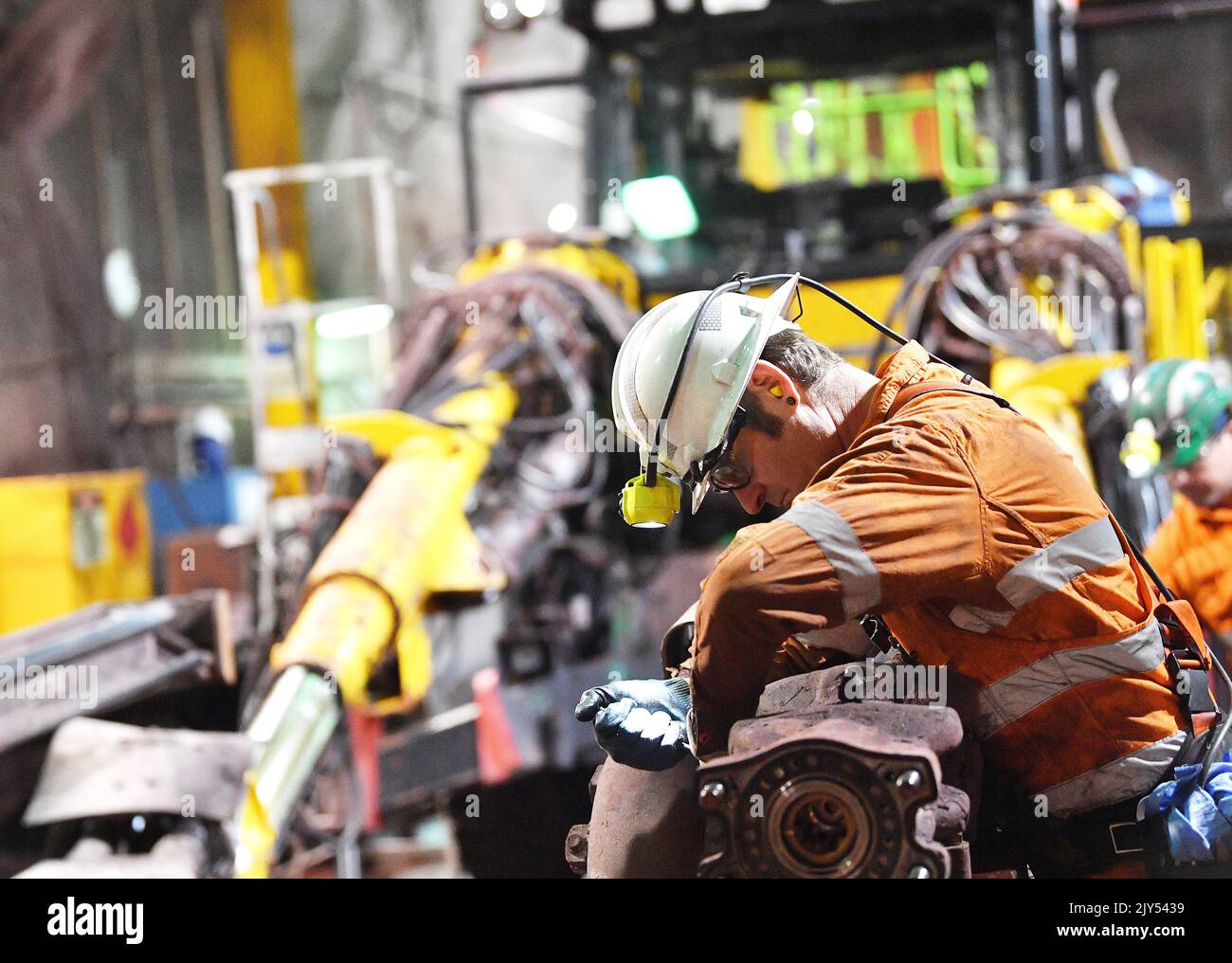 FILE - BHP worker is seen during a tour of the Olympic Dam mine site in ...