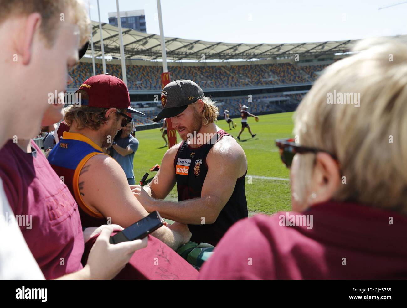 Daniel Rich of Brisbane Lions signs autograph for supporters after a ...